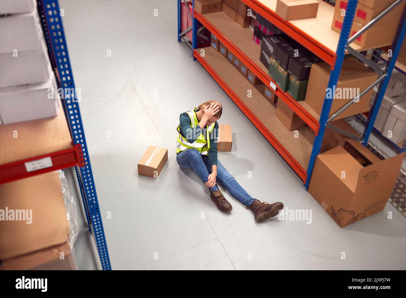 Female Worker With Injured Leg On Floor After Workplace Accident In ...