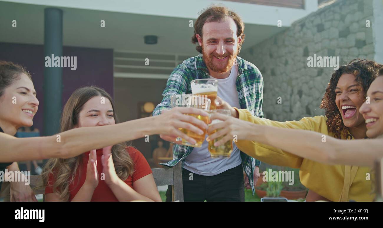 Diverse group of friends toasting. people toast during barbecue garden ...