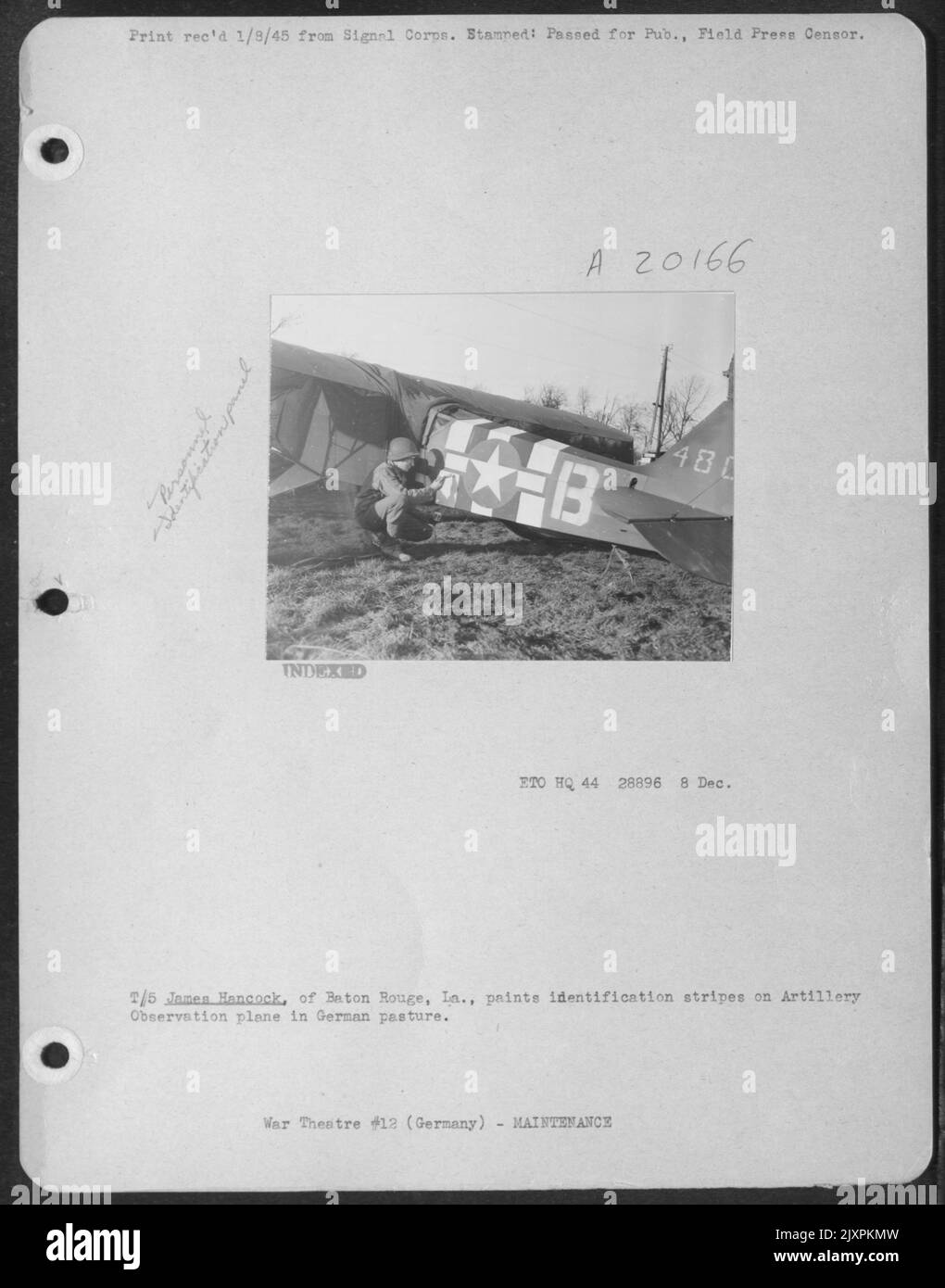 T/5 James Hancock, of Baton Rouge, La., paints identification stripes ...