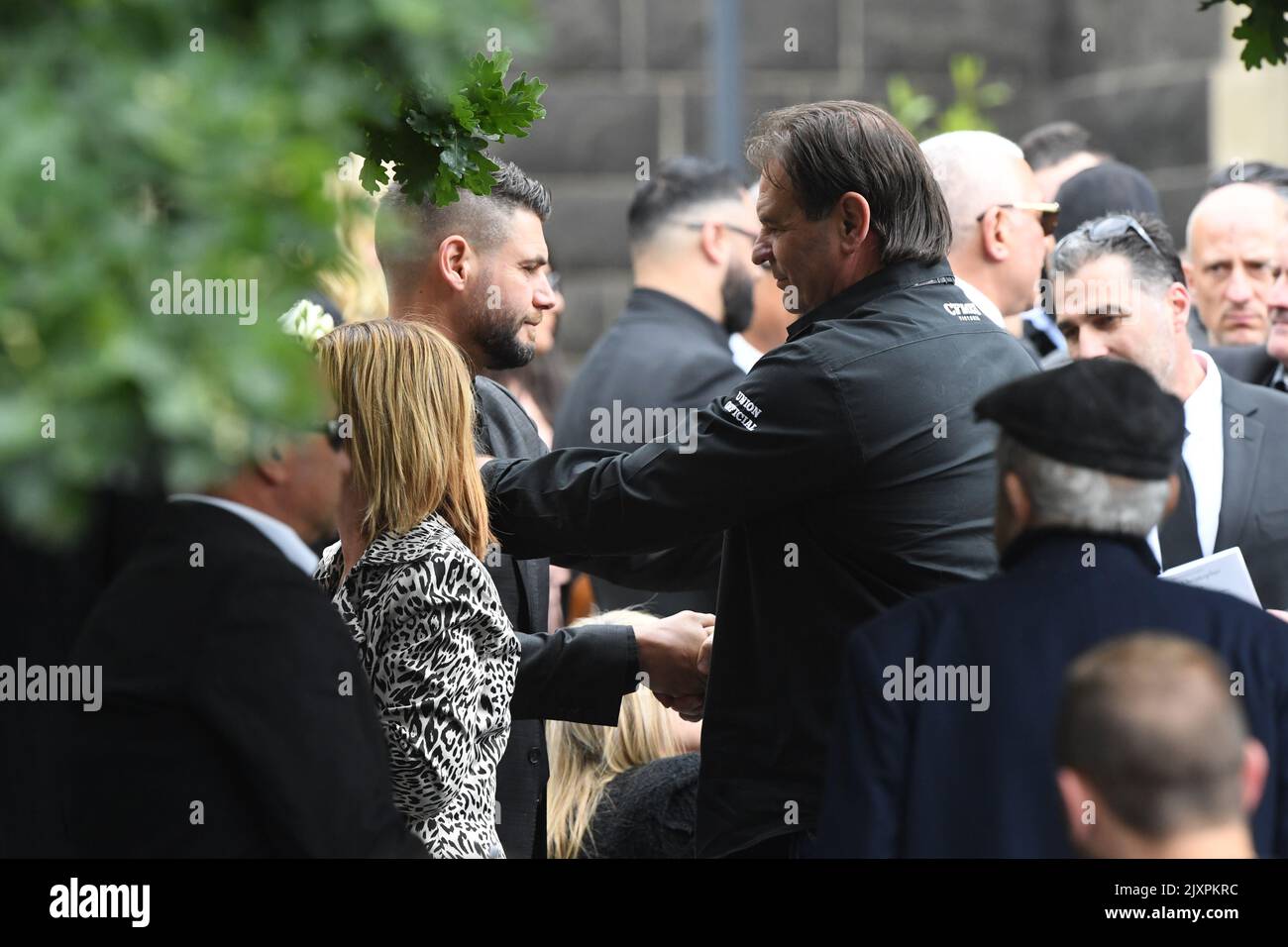 John Setka (right) of CMFEU is seen with mourners after the funeral ...