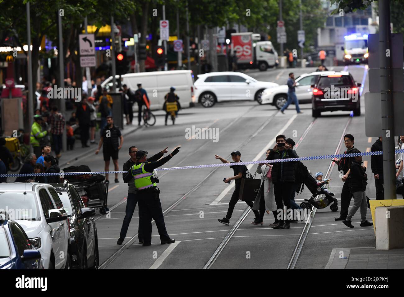 Police are seen redirecting pedestrians away from an incident on Bourke ...
