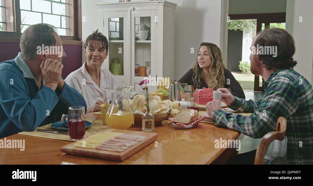 Family having breakfast together talking. Middle aged married couple in ...