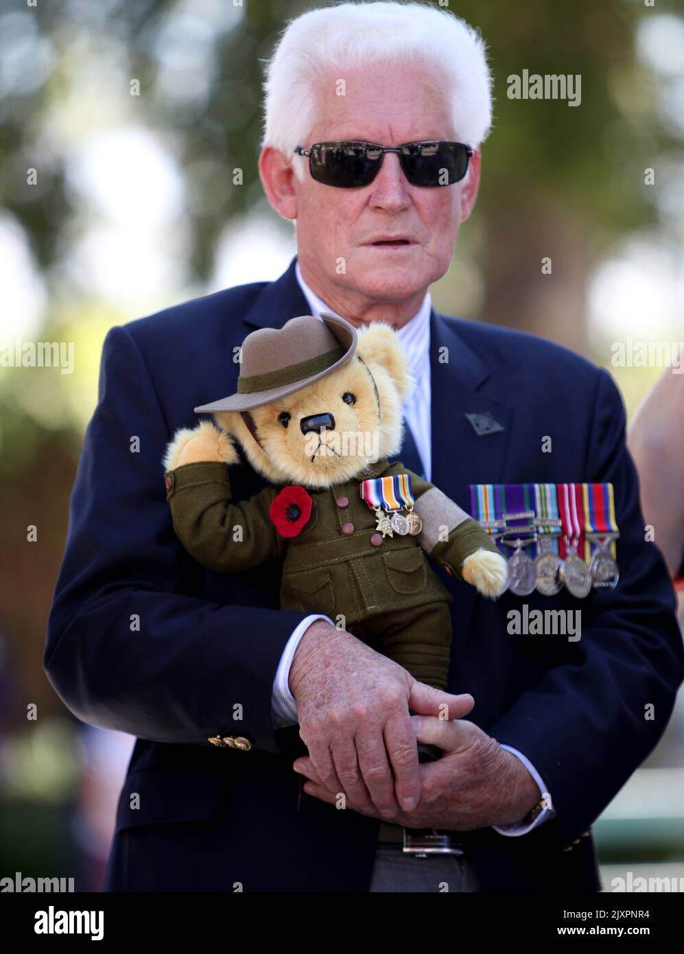 Don Cameron holds a ANZAC teddy bear during Remembrance Day in Adelaide ...