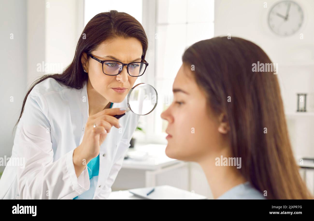 Doctor examines through magnifying hi-res stock photography and images ...