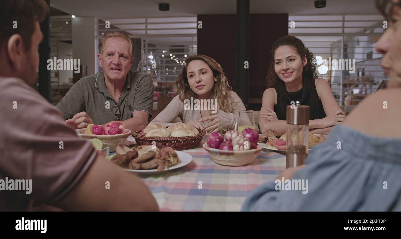 Family and friends gathered outside the house at night in home backyard ...