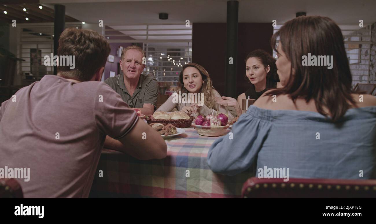 Family and friends gathered outside the house at night in home backyard ...