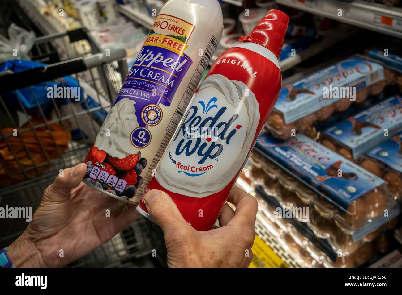A shopper chooses between cans of the ConAgra Foods product, Reddi-wip ...