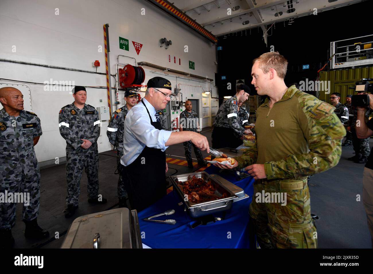 Prime Minister Scott Morrison serves bacon on the Canberra class HMAS ...