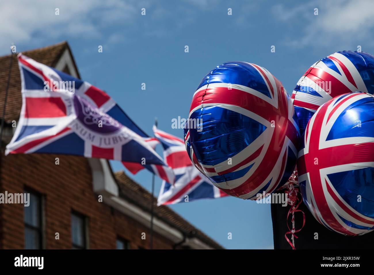 Special Platinum Jubilee Union flags and balloons fly against a blue ...