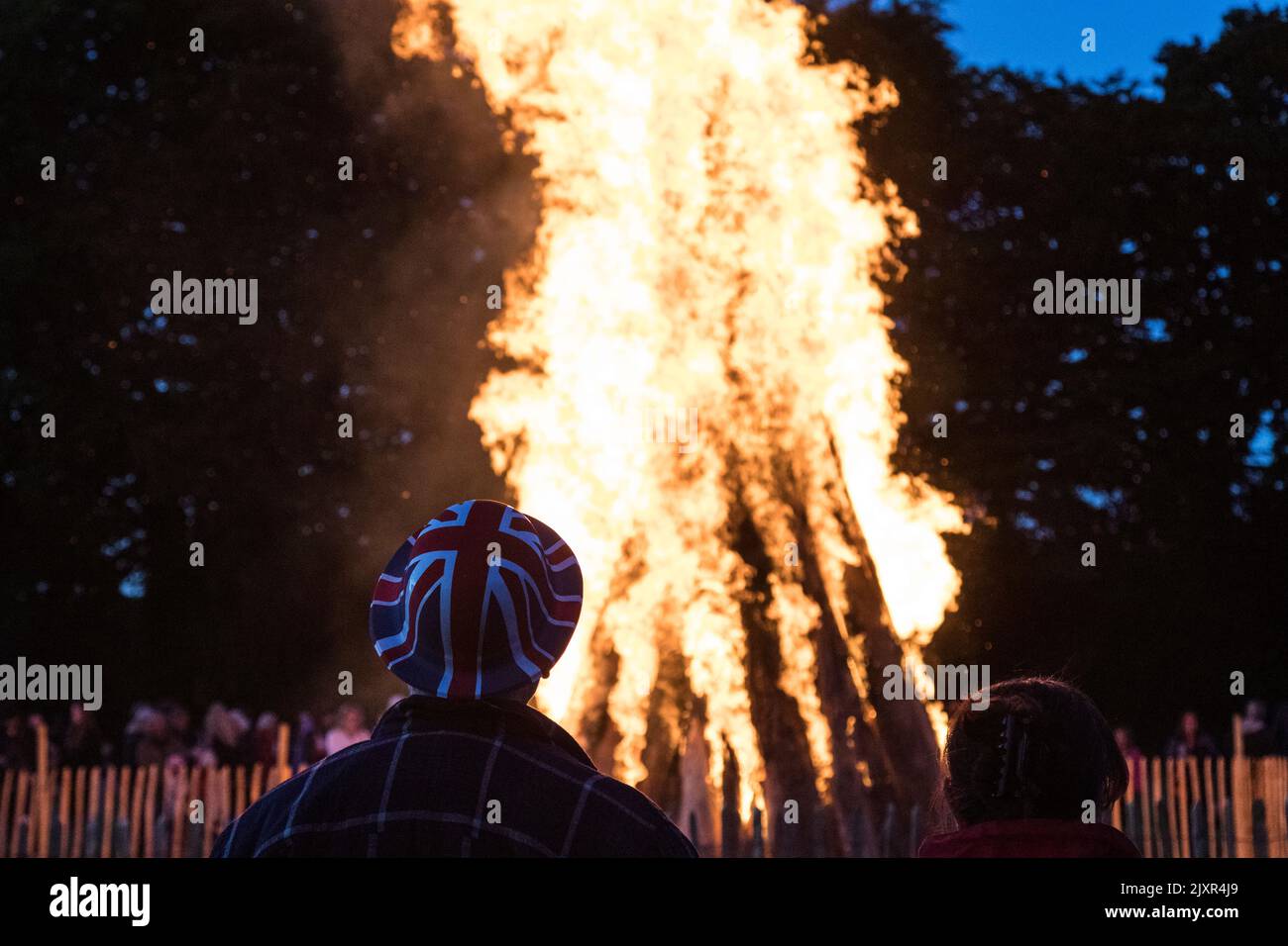 A man wearing a Union flag hat watches the Queen's Platinum Jubilee ...
