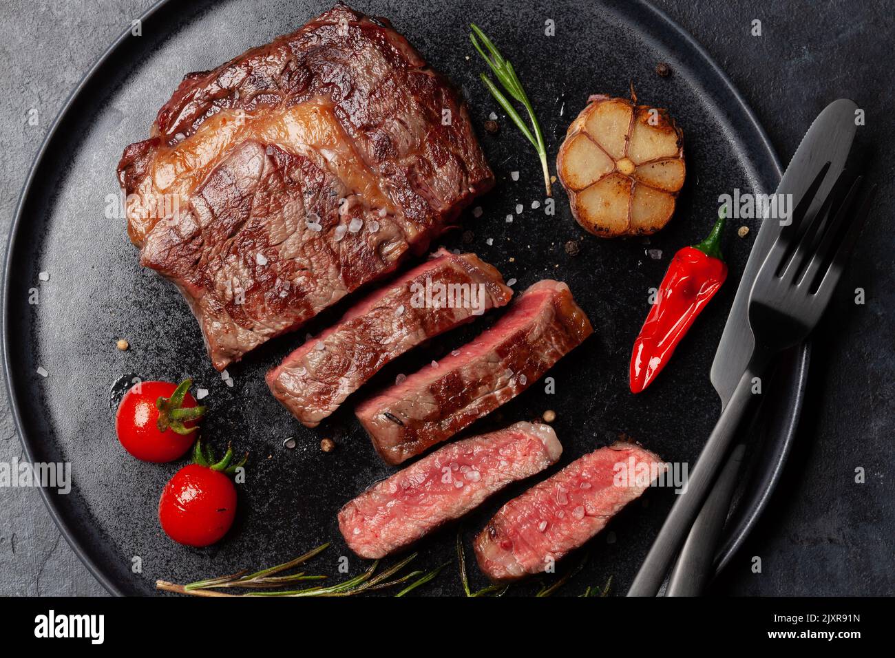 Grilled ribeye beef steak with herbs and spices. Flat lay Stock Photo ...
