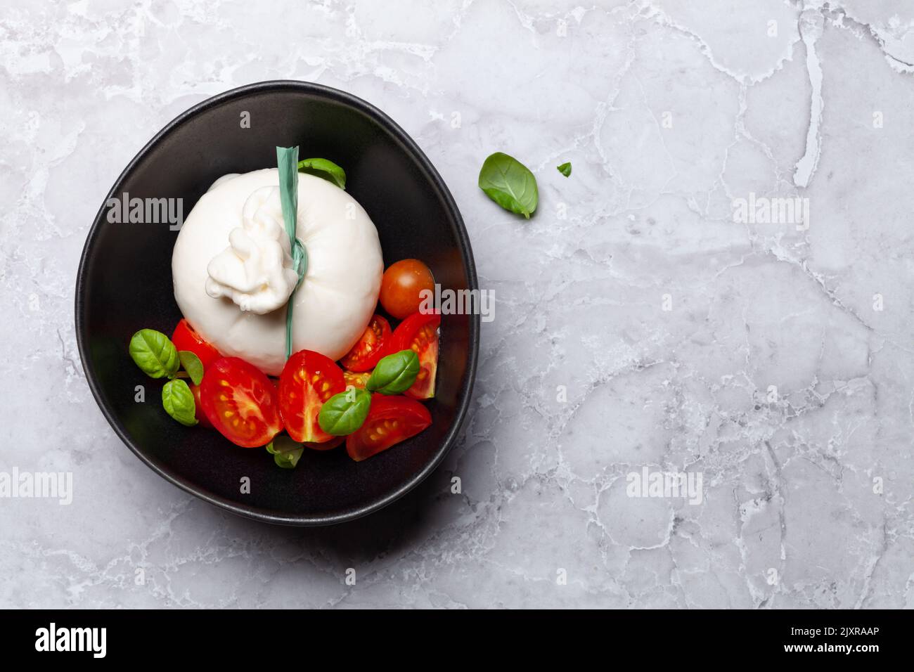 Burrata cheese, cherry tomatoes and basil. Italian cuisine. Flat lay ...