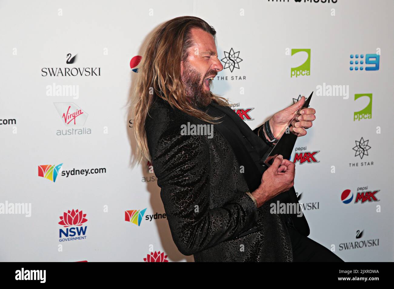 Scott Maxwell poses for a photograph after winning the Music Teacher of ...