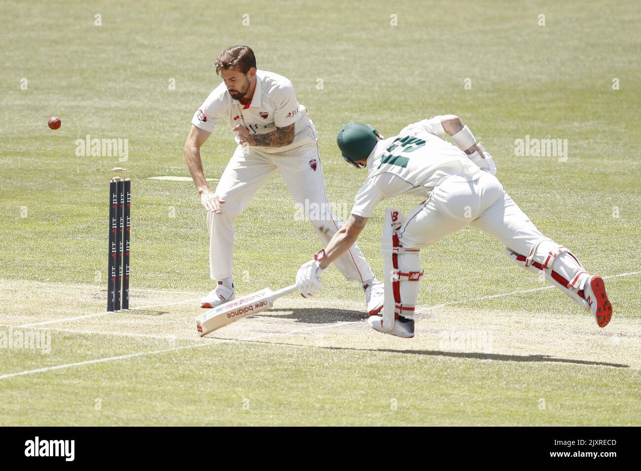 Matthew Wade of Tasmania (right) is almost run-out during day 3 of the ...