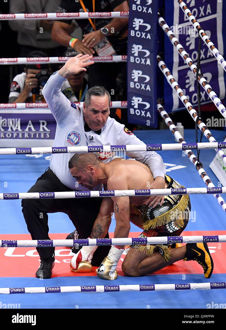 The referee calls off the bout as Australian boxer Anthony Mundine ...