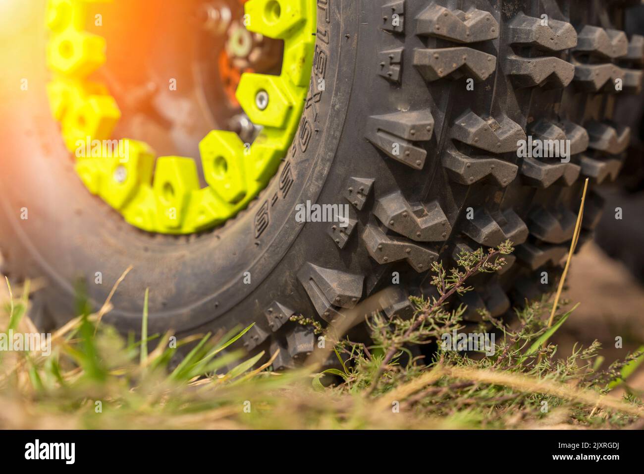 Close-up of the ATV wheel on sandy ground Stock Photo - Alamy