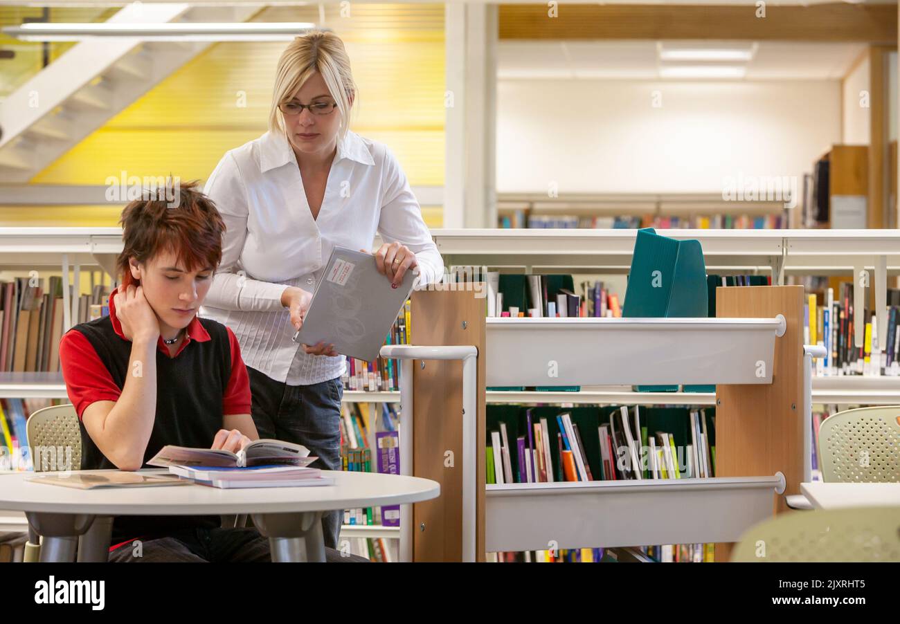 Teenage Students Library Scene An Adult Librarian Helping A Student Teenage Students Library Scene An Adult Librarian Helping A Student