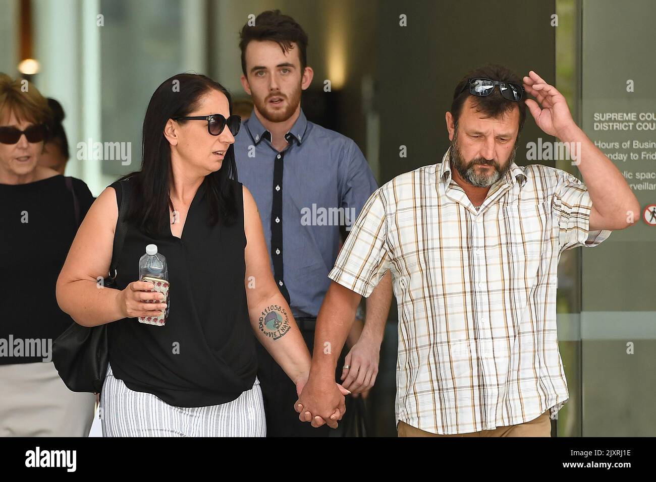 The sister (left) and son (centre) of victim Michelle Reynolds are seen ...
