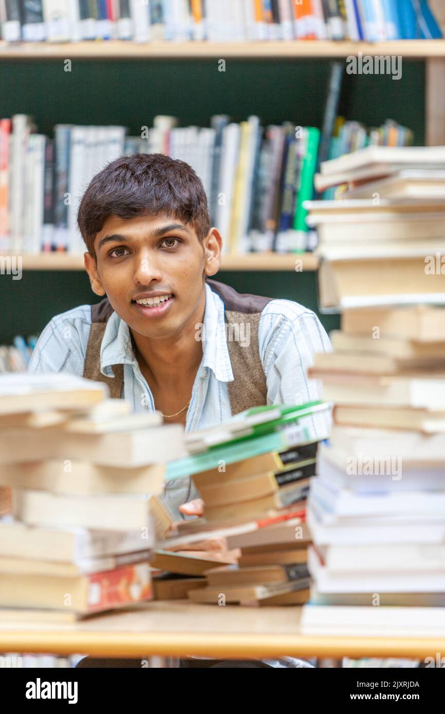 Teenage Students: Bookworm. A boy pupil of Indian heritage making use ...