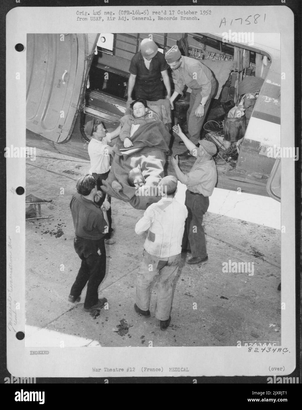 A Wounded Soldier Is Removed From A Douglas C-47 Evacuation Plane Of ...