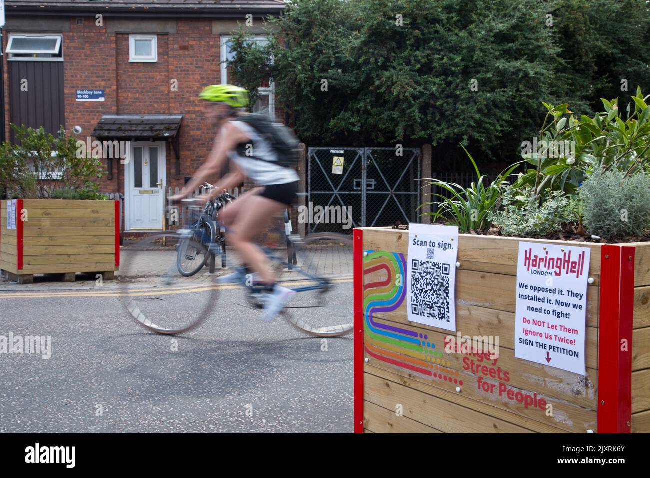 A cyclist passes through barriers signalling a controversial LTN (Low ...