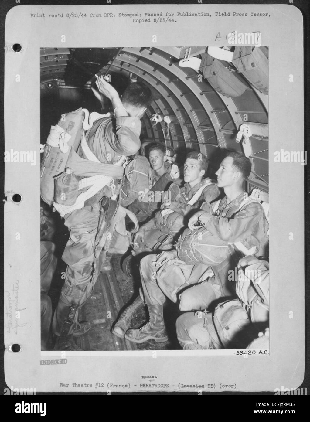 The Jumpmaster (standing) gives final instructions to this group of ...