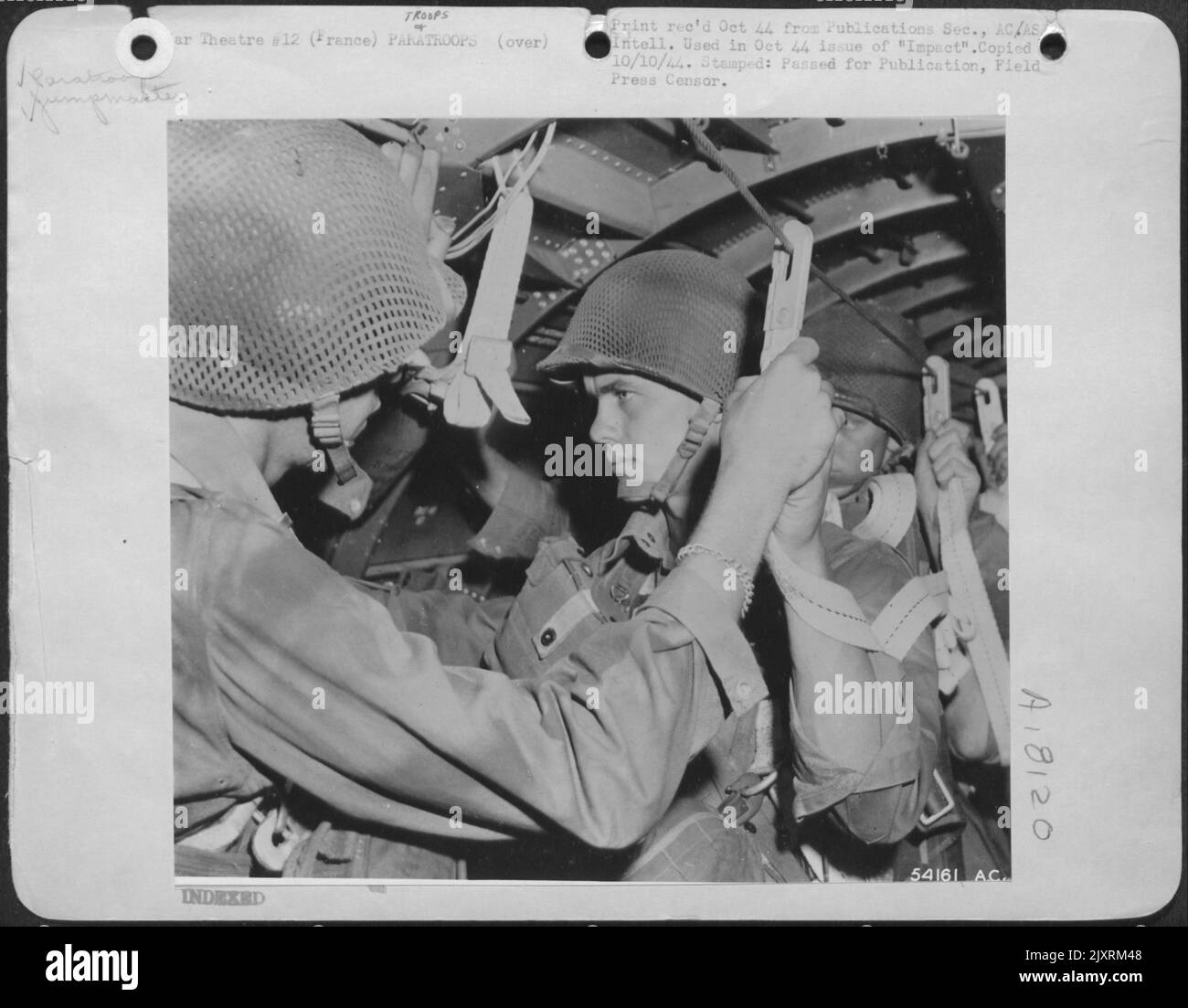 FRANCE-Grim, well-trained, these paratroopers hook their static lines ...