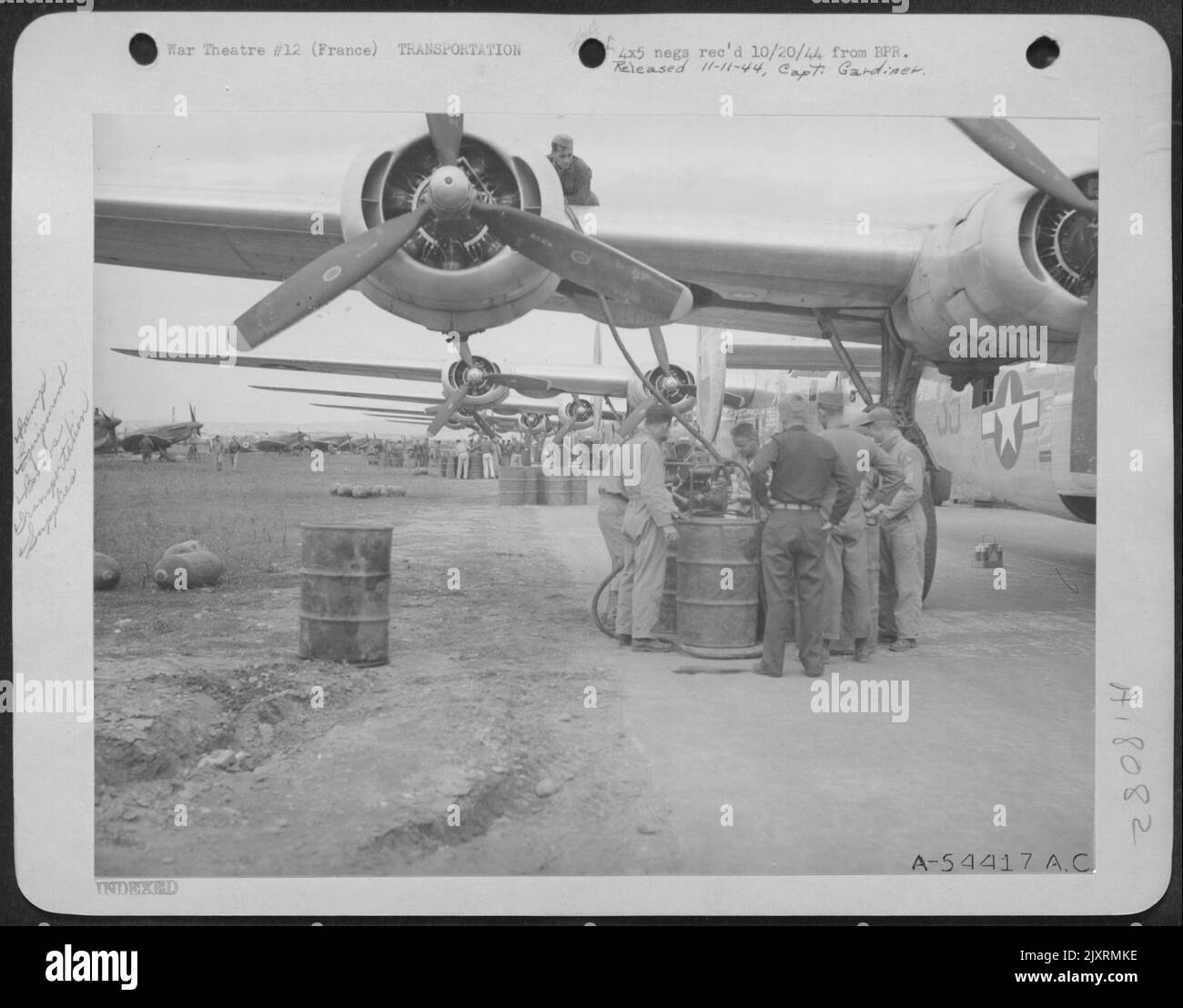 Filling gas drums from wing tanks of Consolidated B-24 Liberators of ...