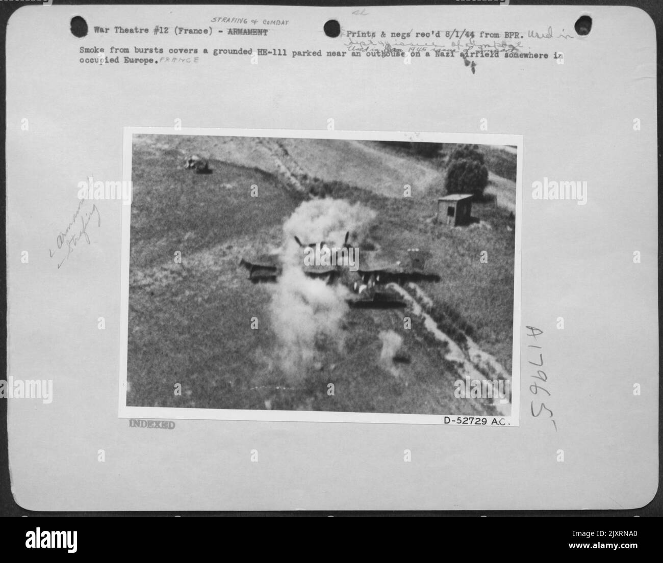 Smoke from bursts covers a grounded HE-111 parked near an outhouse on a ...