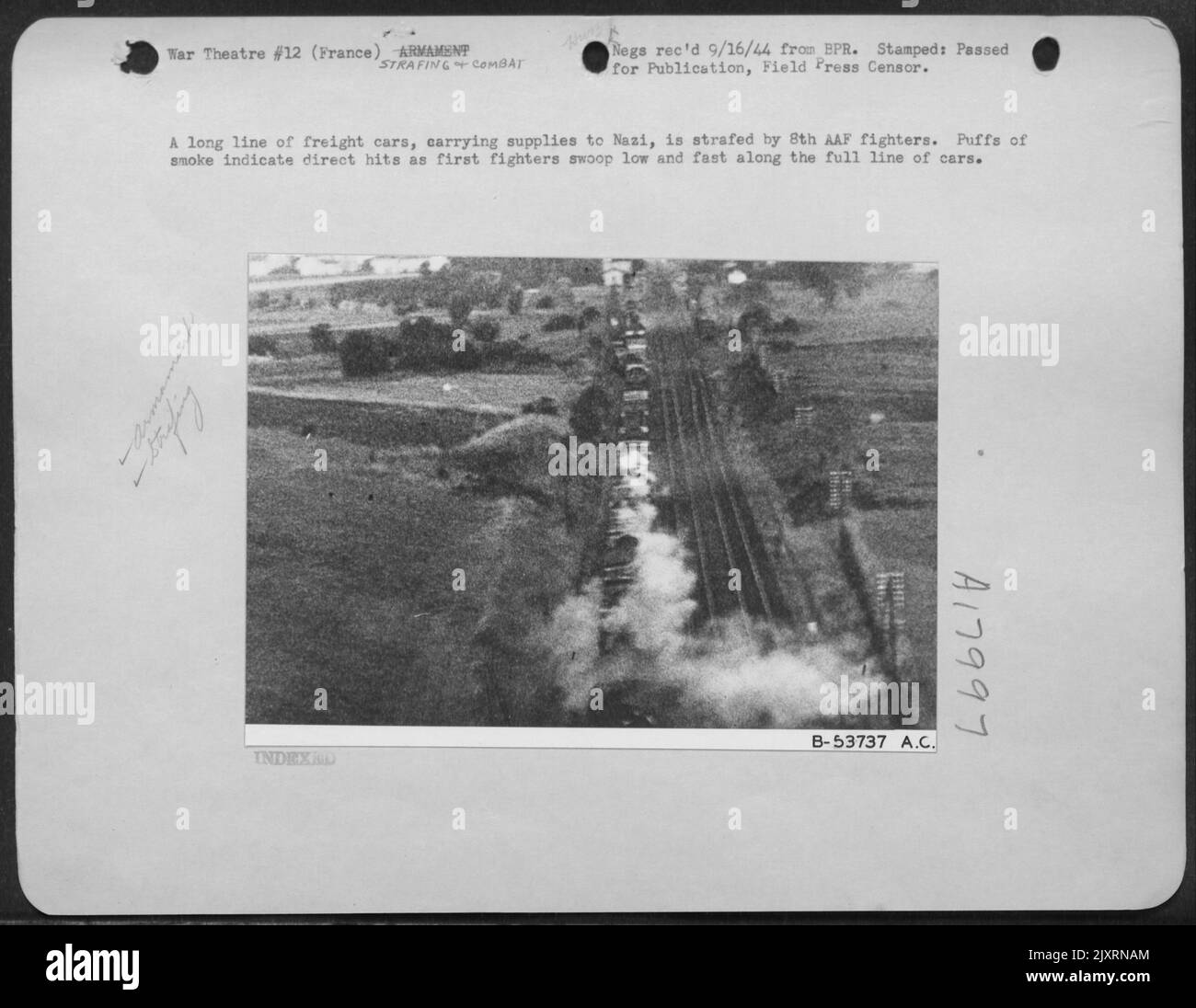 A long line of freight cars, carrying supplies to Nazi, is strafed by ...