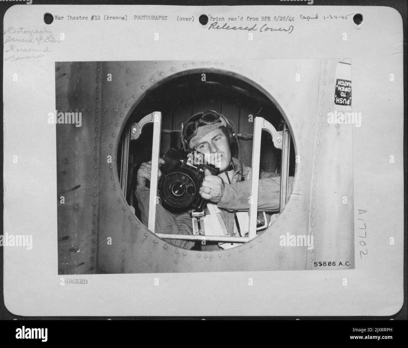 Sgt Robert O. Beerman photographing target through camera hatch in ...