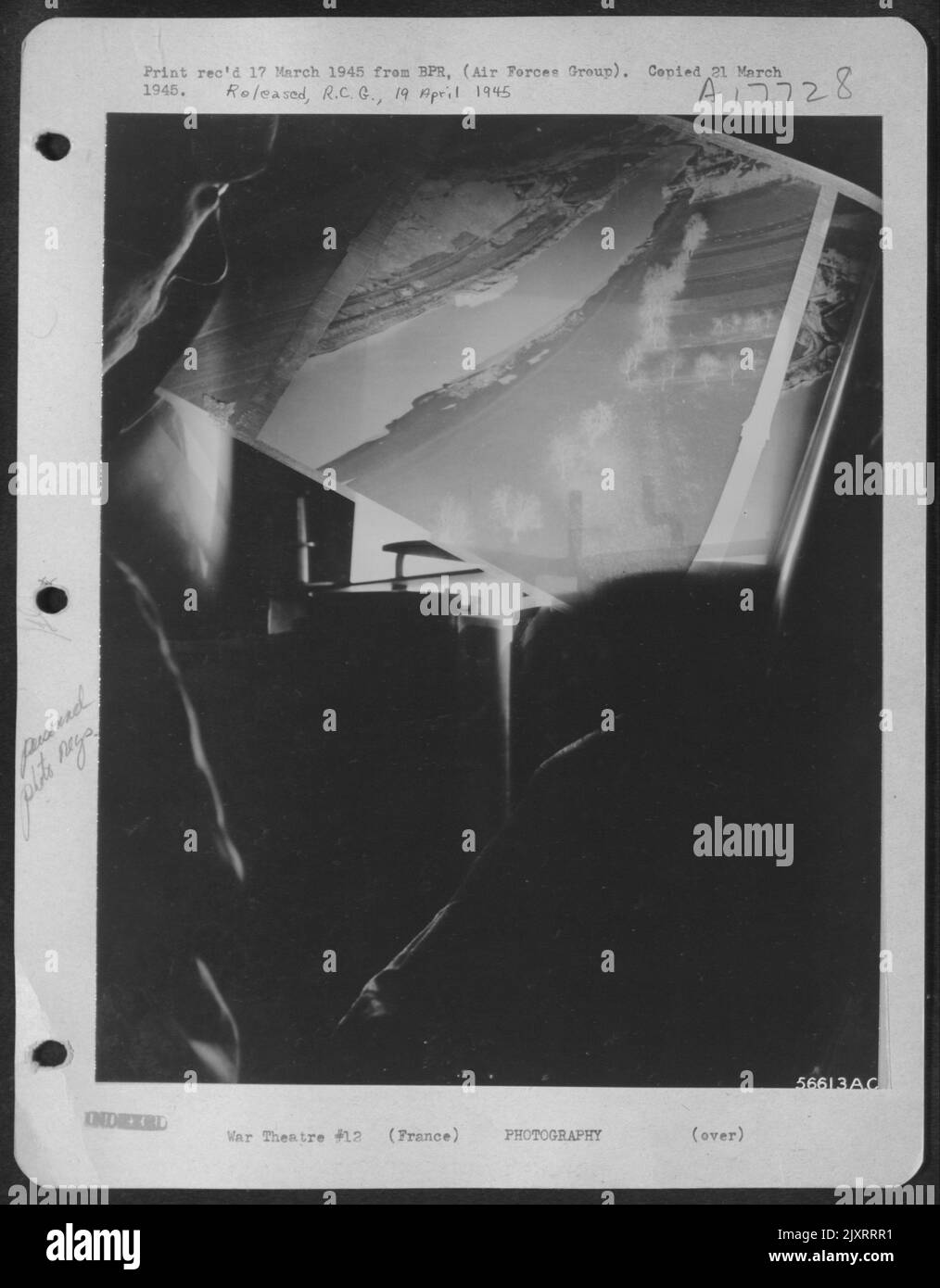 FRANCE--Development completed, film is viewed against a light to make a ...