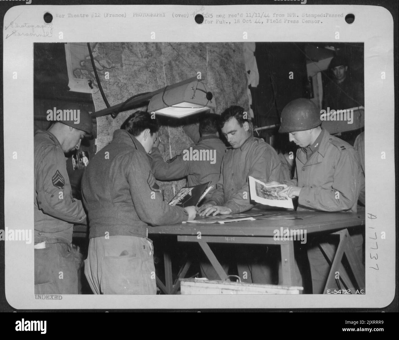 Looking over some finished prints in a photo lab of a Photo Recon Unit ...