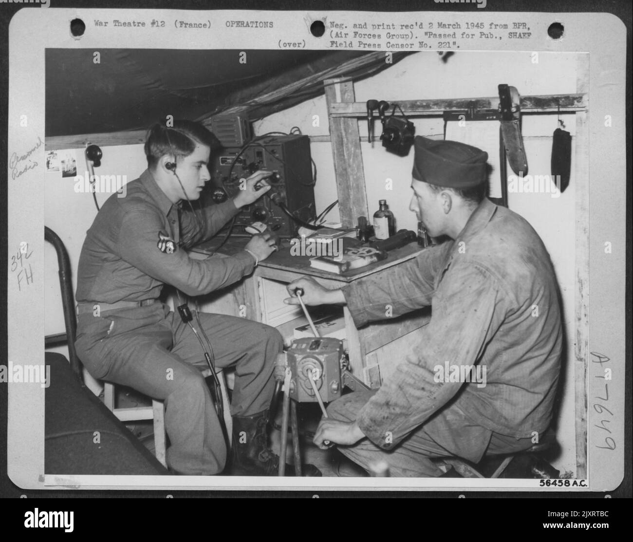 T/5 Thomas Hertzog, Belvedere, N.J., checks the radio at a searchlight ...