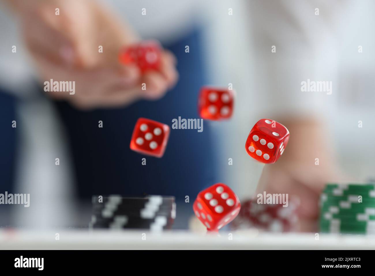 Five red dice are discarded from hand Stock Photo - Alamy