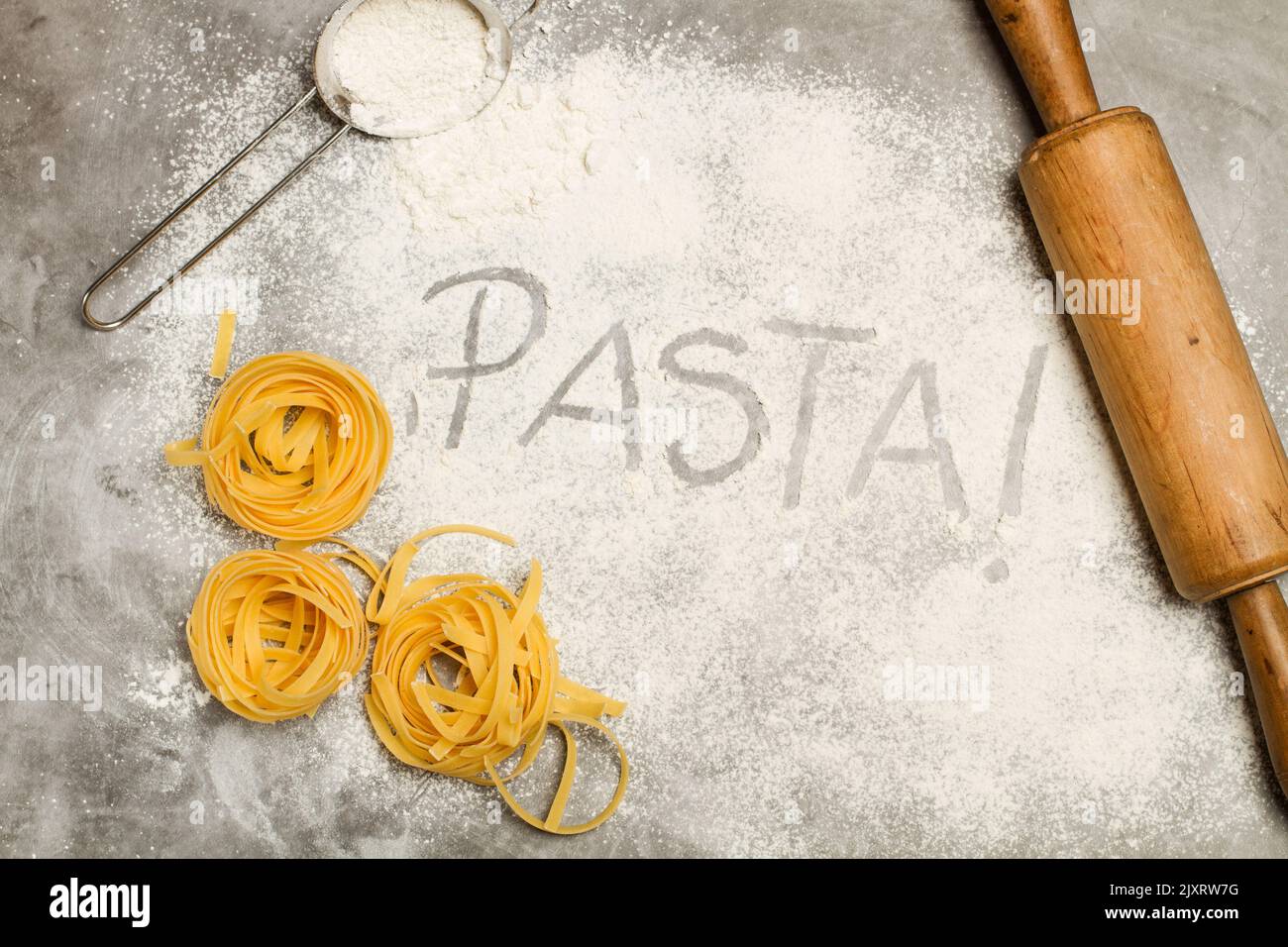 Noodles and pasta word write on flour on a stone background Stock Photo ...