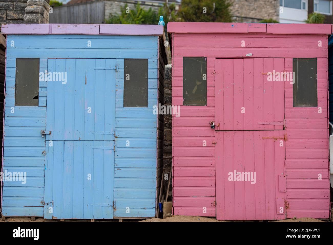 brightly painted old wooden beach huts on the beach at swanage in ...