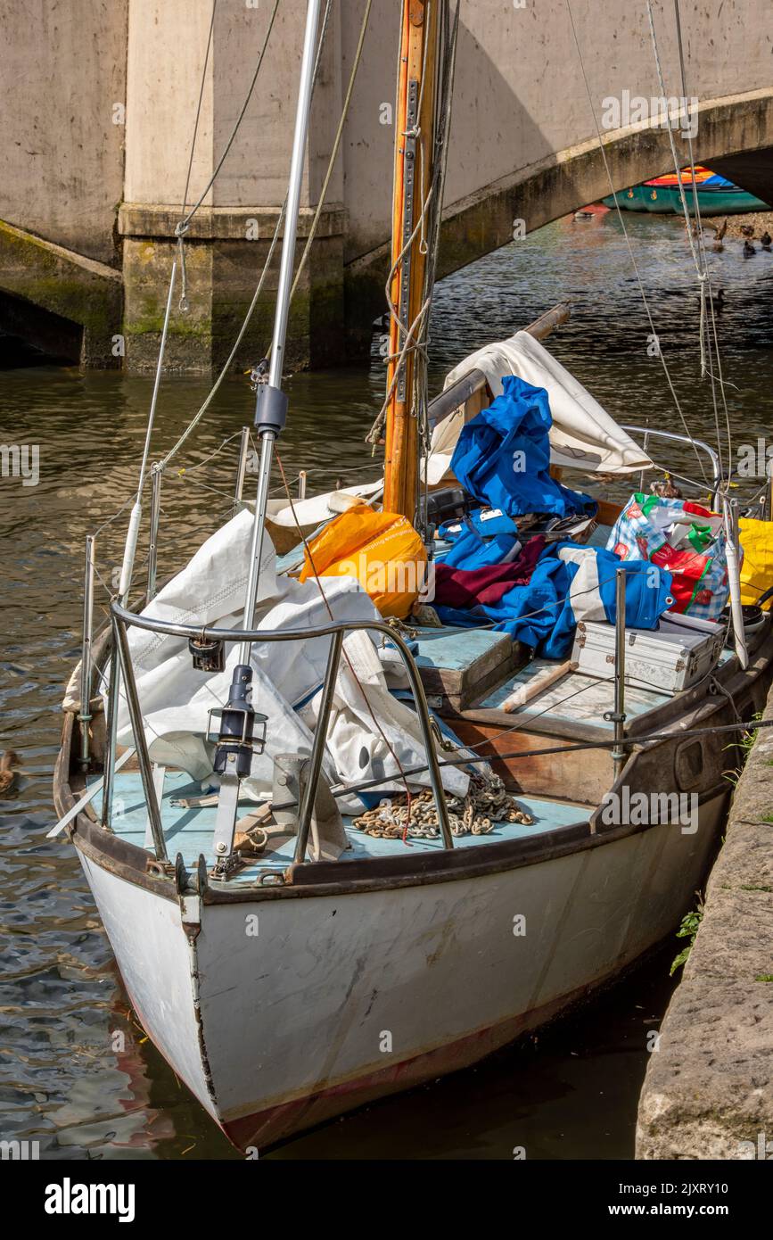 scruffy old wooden sailing yacht alongside a wall in need of tidying ...