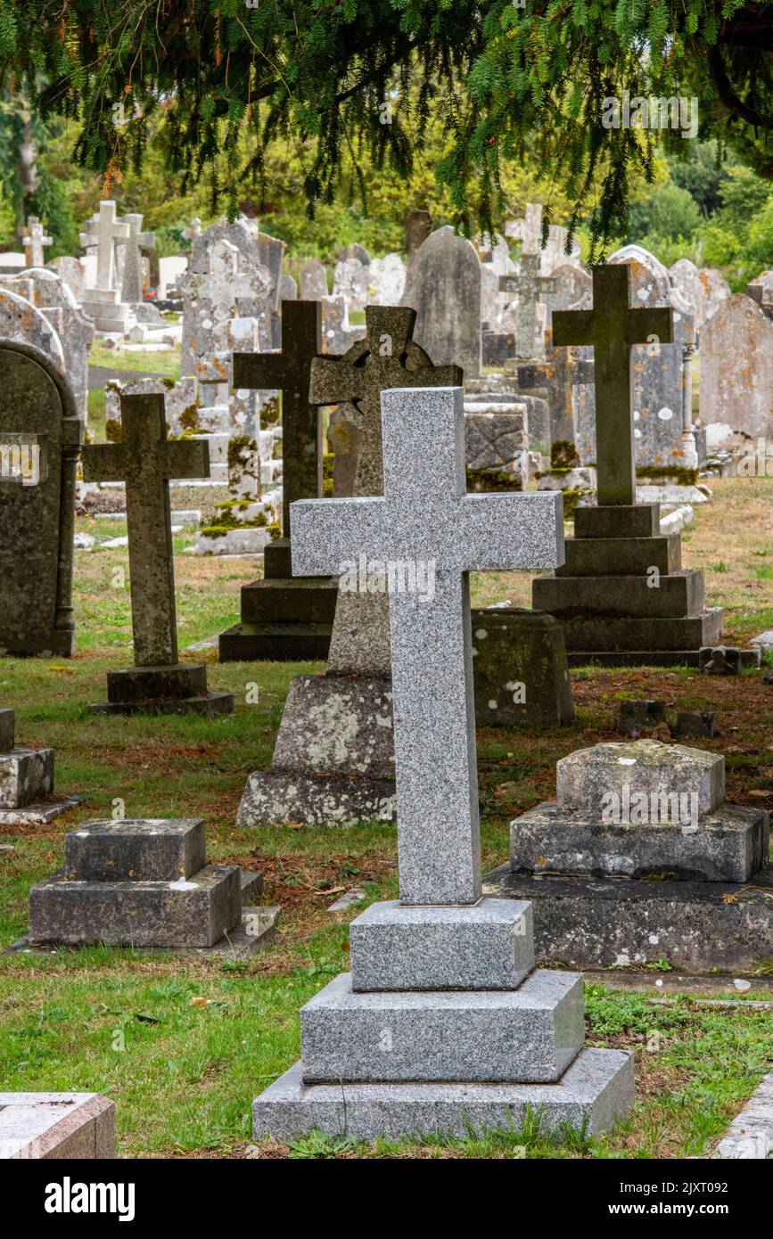 crosses in a churchyard, graveyard with stone headstones, cemetery with ...