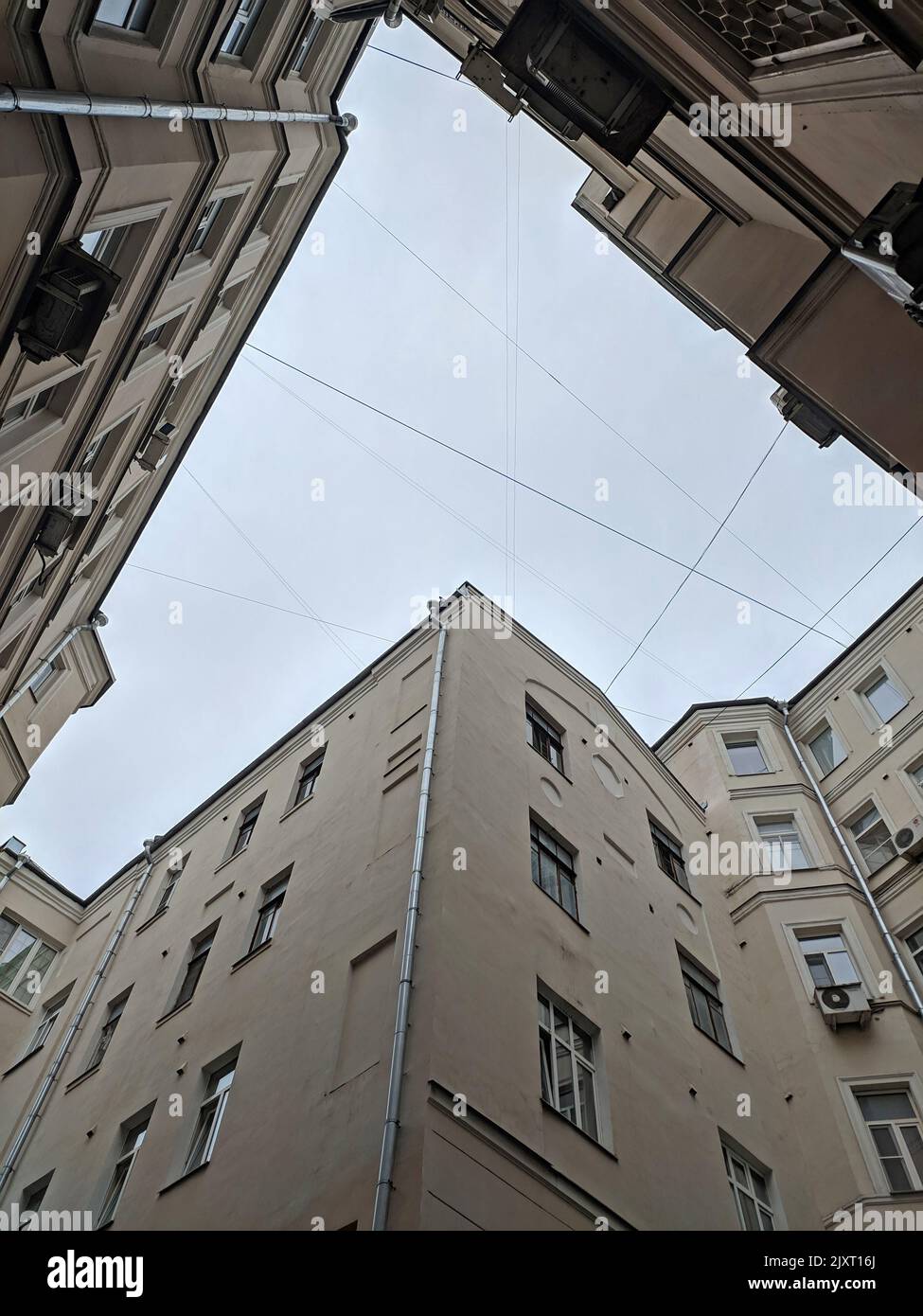 A courtyard with a low angle view. Sky surrounded by buildings and ...
