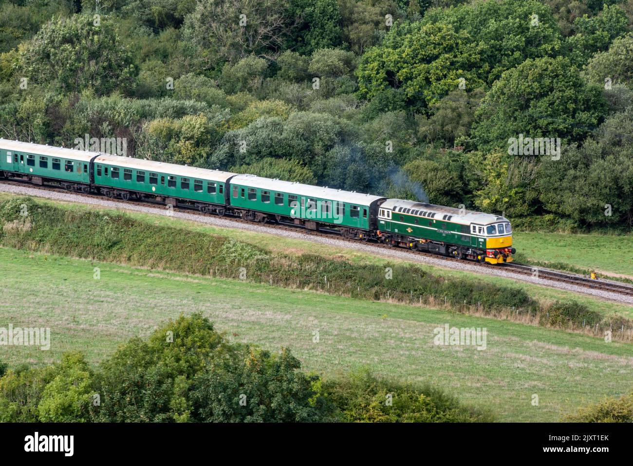 diesel locomotive hauling southern railway green coaches through the ...