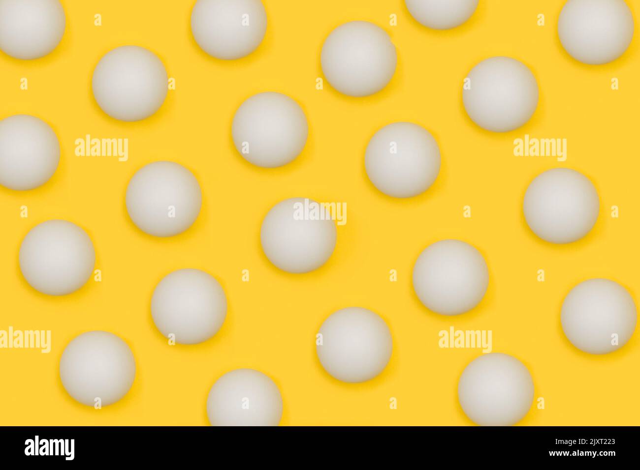 White ping pong balls on a yellow background Stock Photo - Alamy