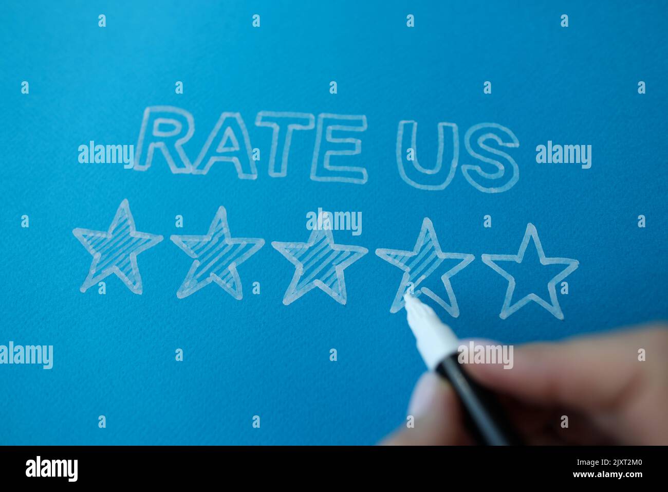 Person marker writes rate feedback to us Stock Photo - Alamy