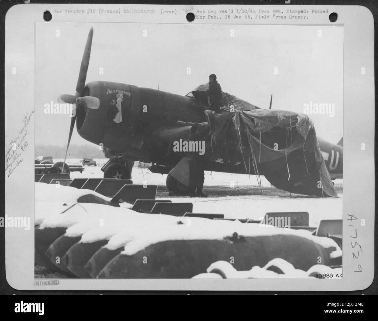 Ground crewmen peel a frozen tarpaulin from the hood of this Republic P ...