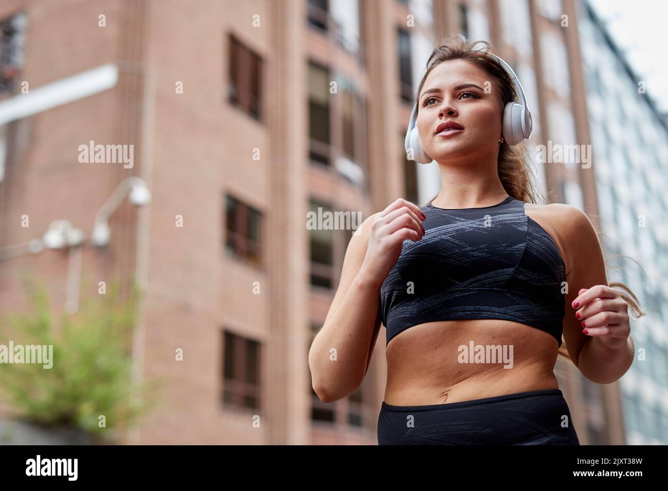 A single female jogger on the streets of Manchester, UK Stock Photo - Alamy