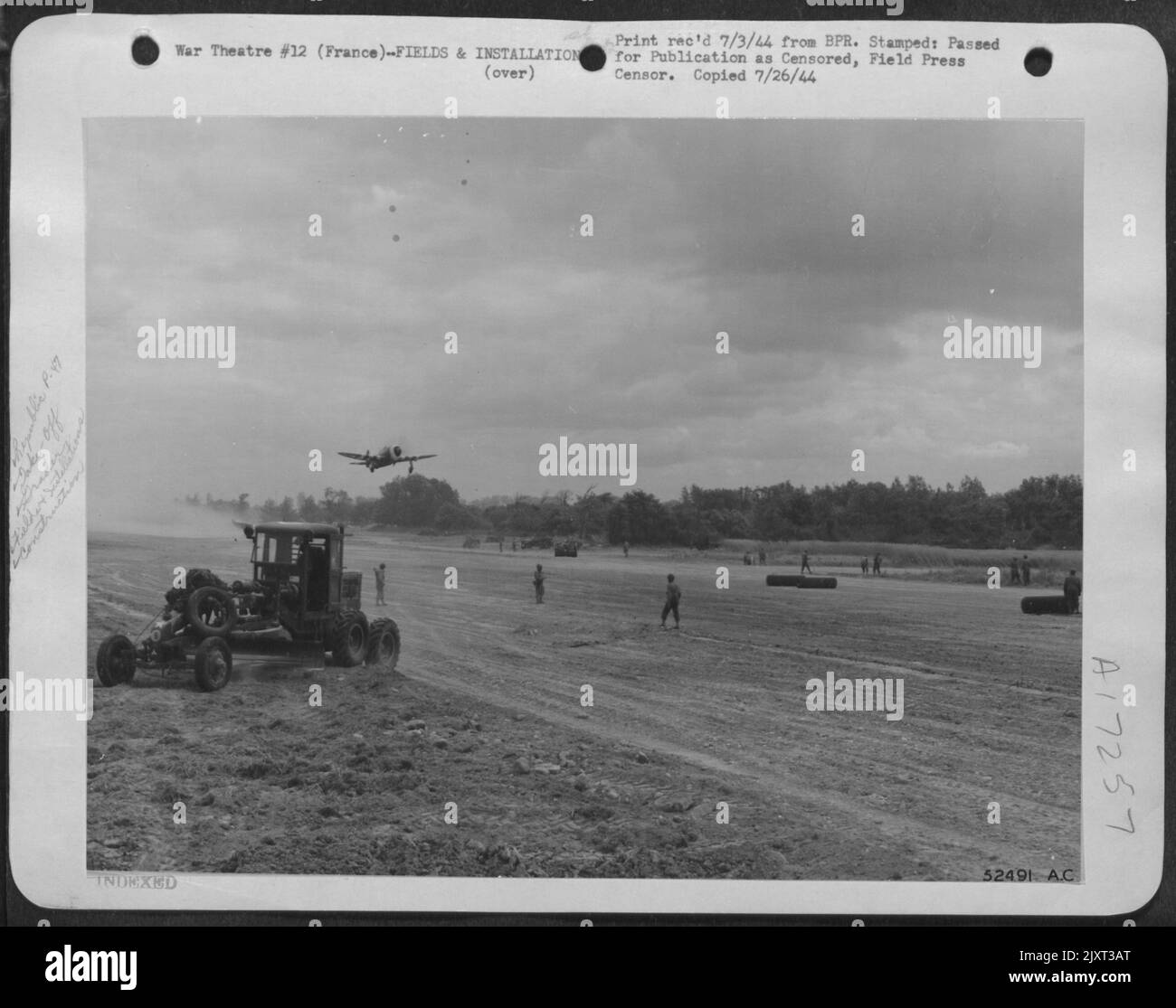 Work continues on this front-line landing strip in France while a ...