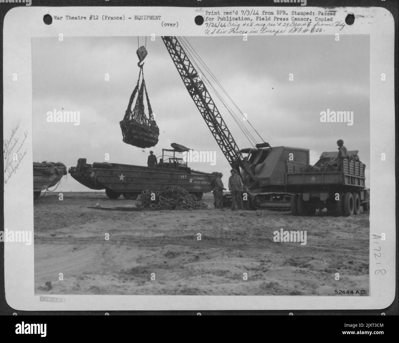 Giant cranes unload high octane gasoline for the 9th AF from ducks and lower it into army trucks ...