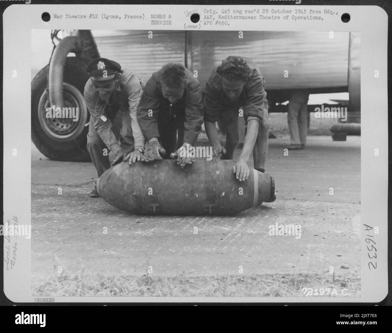 An American And Two British Airmen Roll A 500 Lb. Bomb From A ...