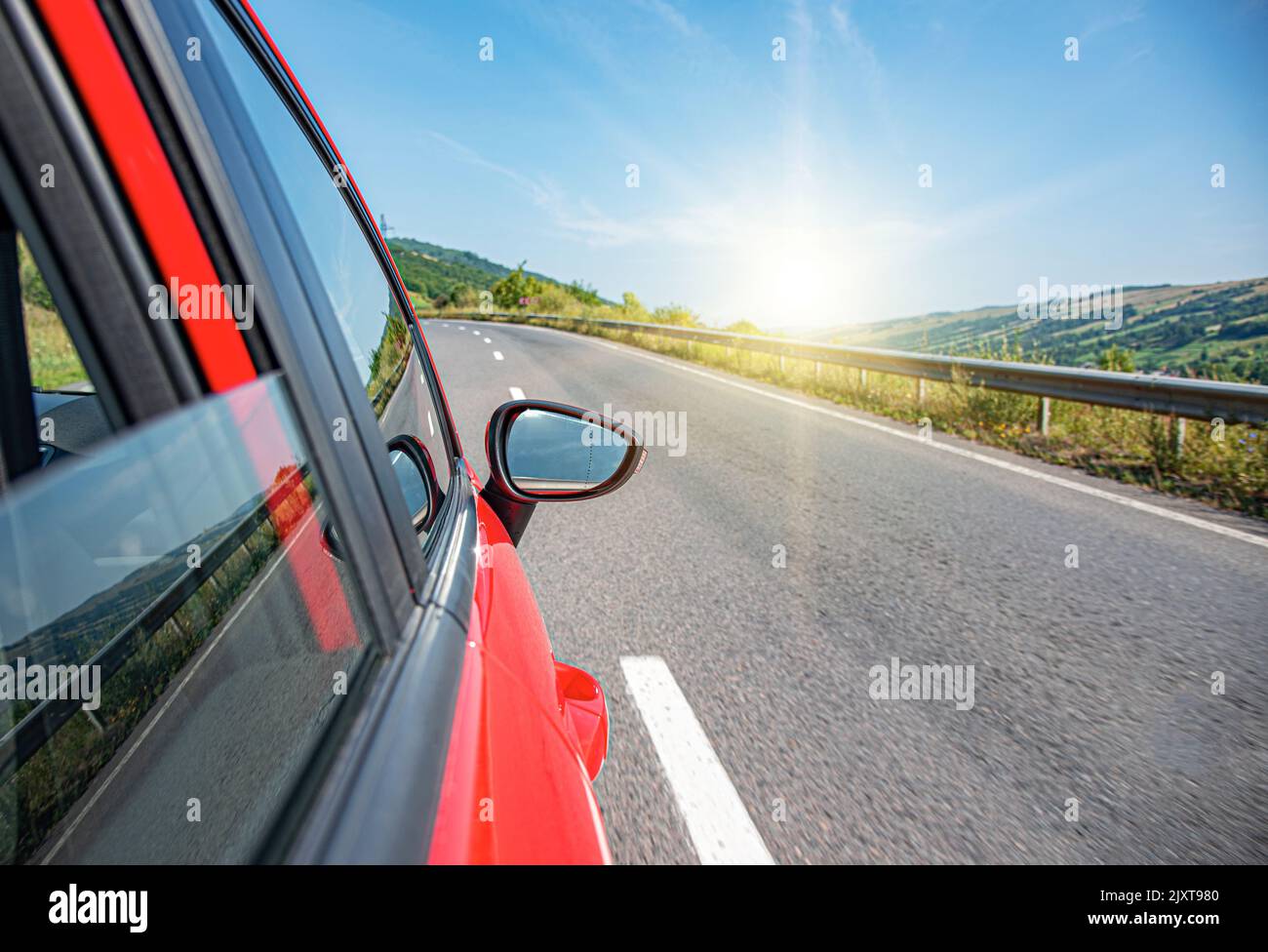 Red car on the road Stock Photo - Alamy
