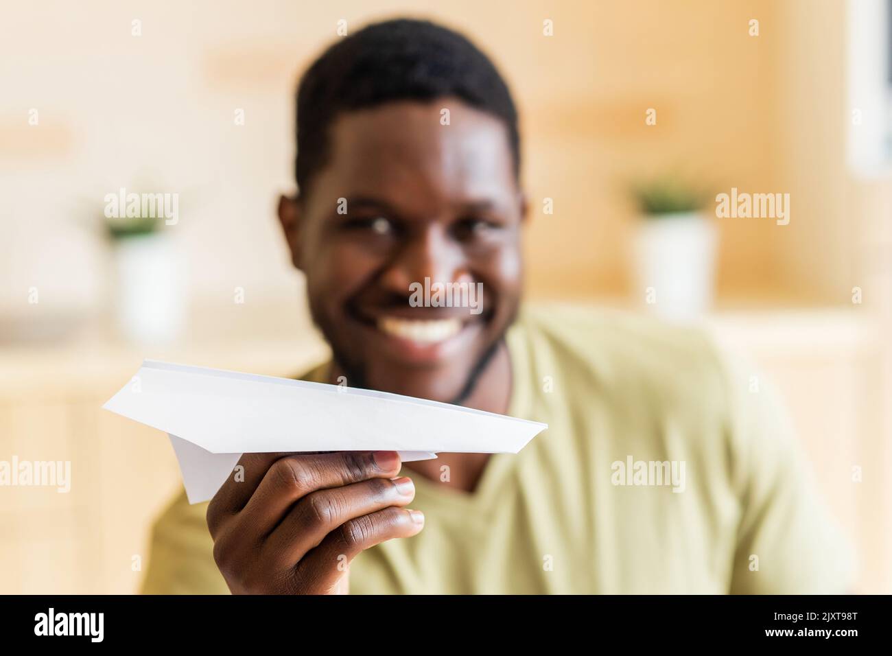 hispanic man throw paper plane and sending a message Stock Photo - Alamy